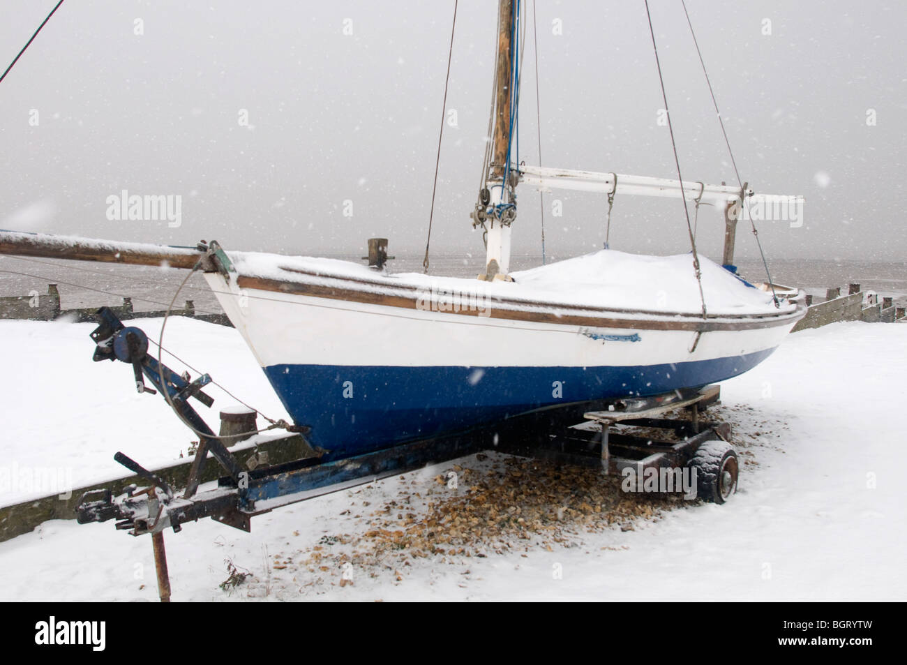 Boat covered in Snow on beach whitstable kent countryside england UK ...