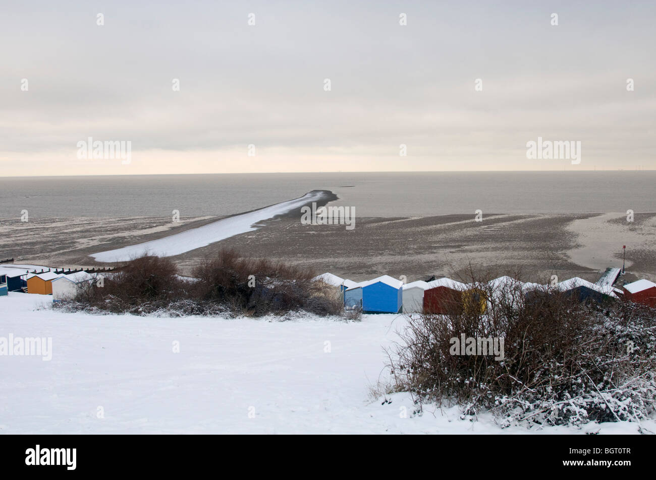 Whitstable shingle street and beach huts at low tide in Snow tankerton ...