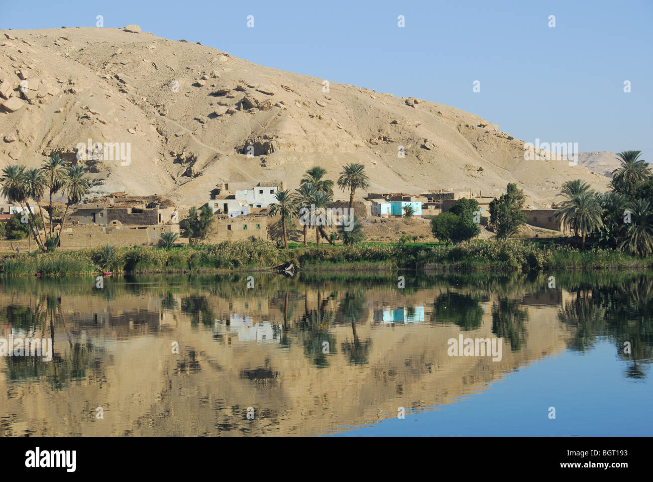 RIVER NILE, UPPER EGYPT. A Nile village reflected in the river. 2009 ...