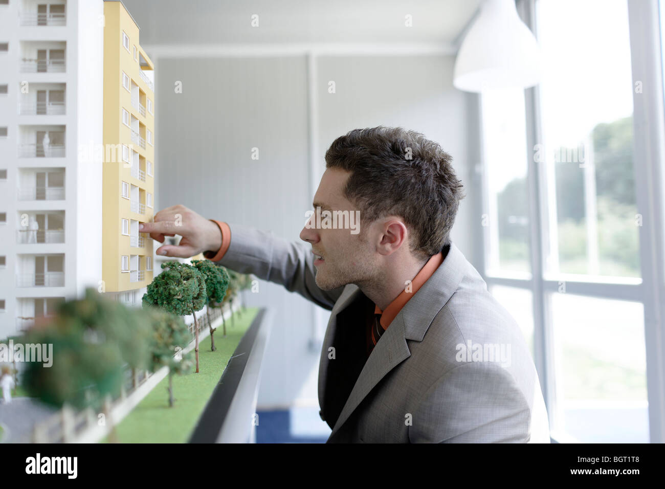 man looking at an architectural model building Stock Photo - Alamy