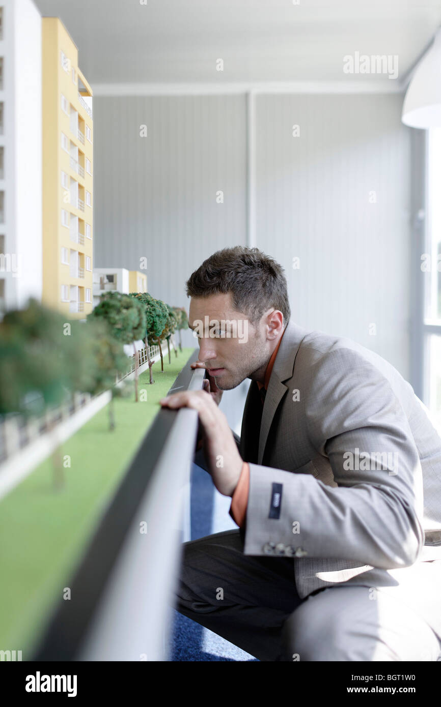 man looking at an architectural model building Stock Photo - Alamy
