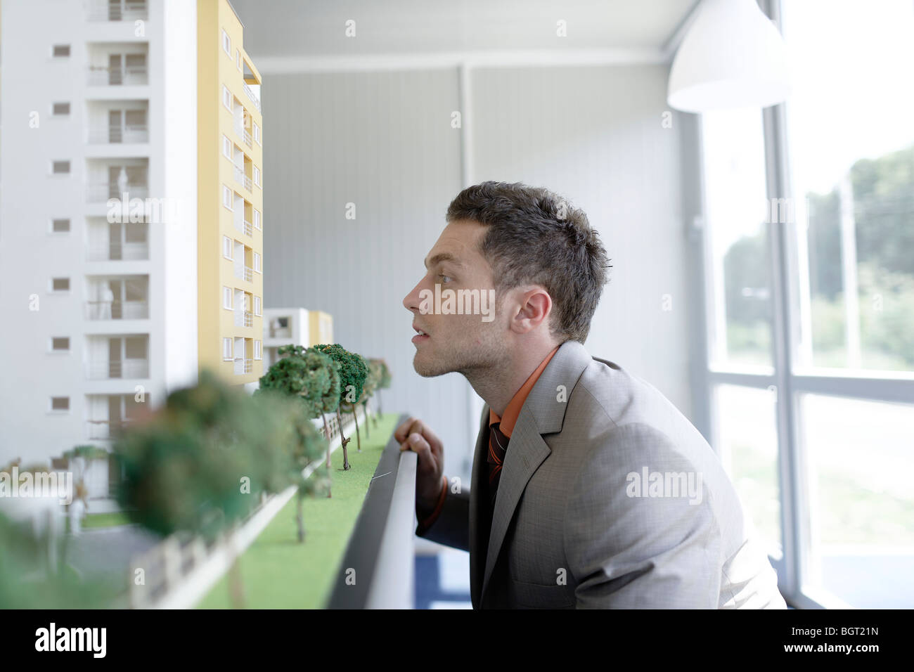 man looking at an architectural model building Stock Photo - Alamy