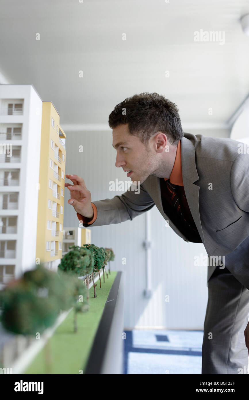 man looking at an architectural model building Stock Photo - Alamy