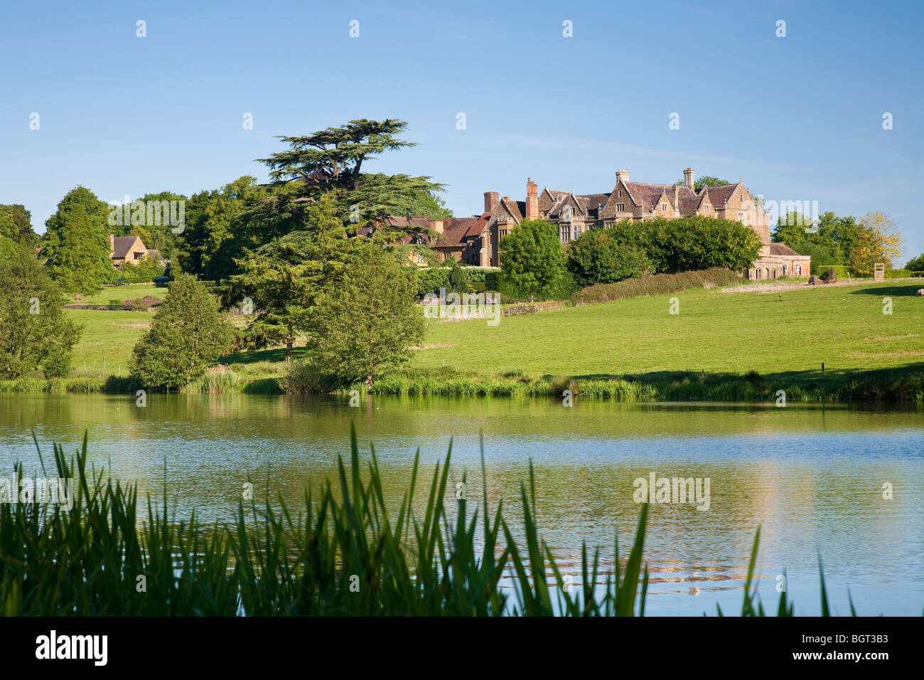 Fawsley Hall Hotel seen across the lake Stock Photo - Alamy