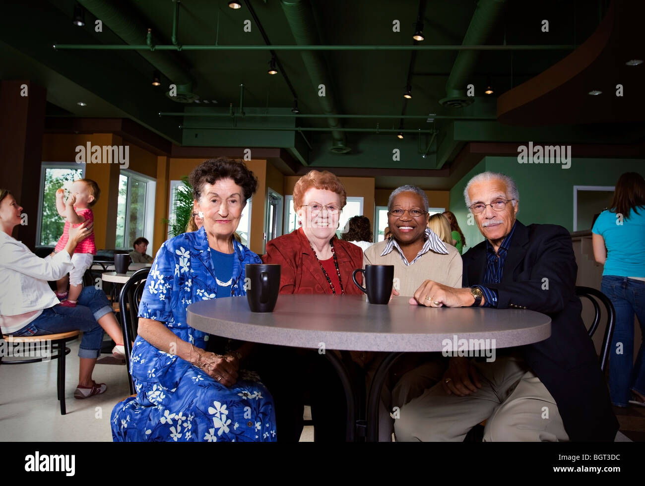 Friends sitting together Stock Photo - Alamy