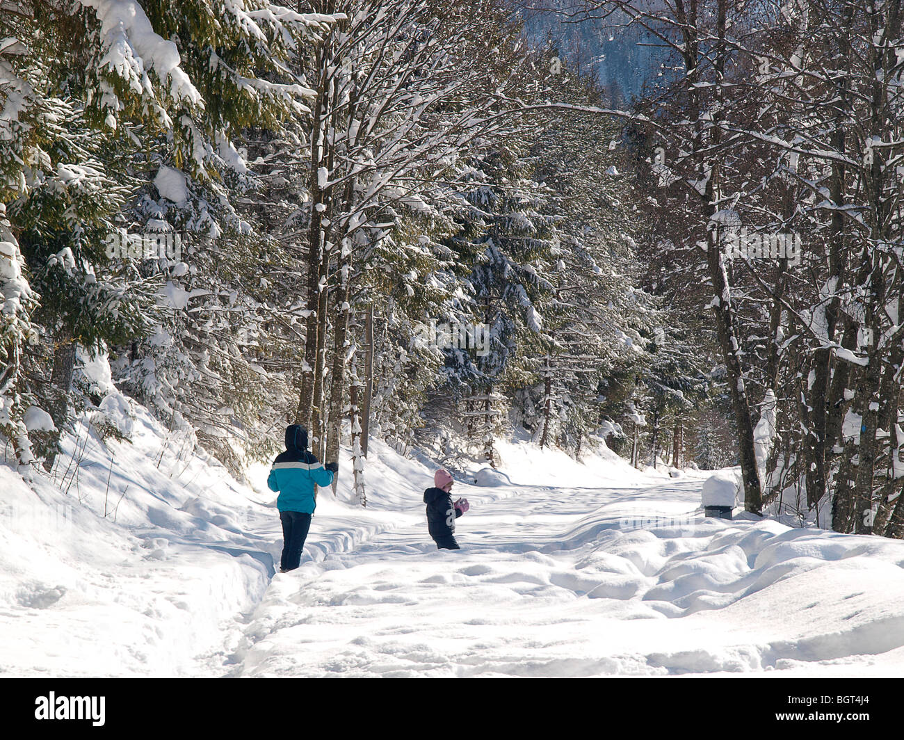 Lifestyle picture of a Mother and a child playing in the deep snow in ...