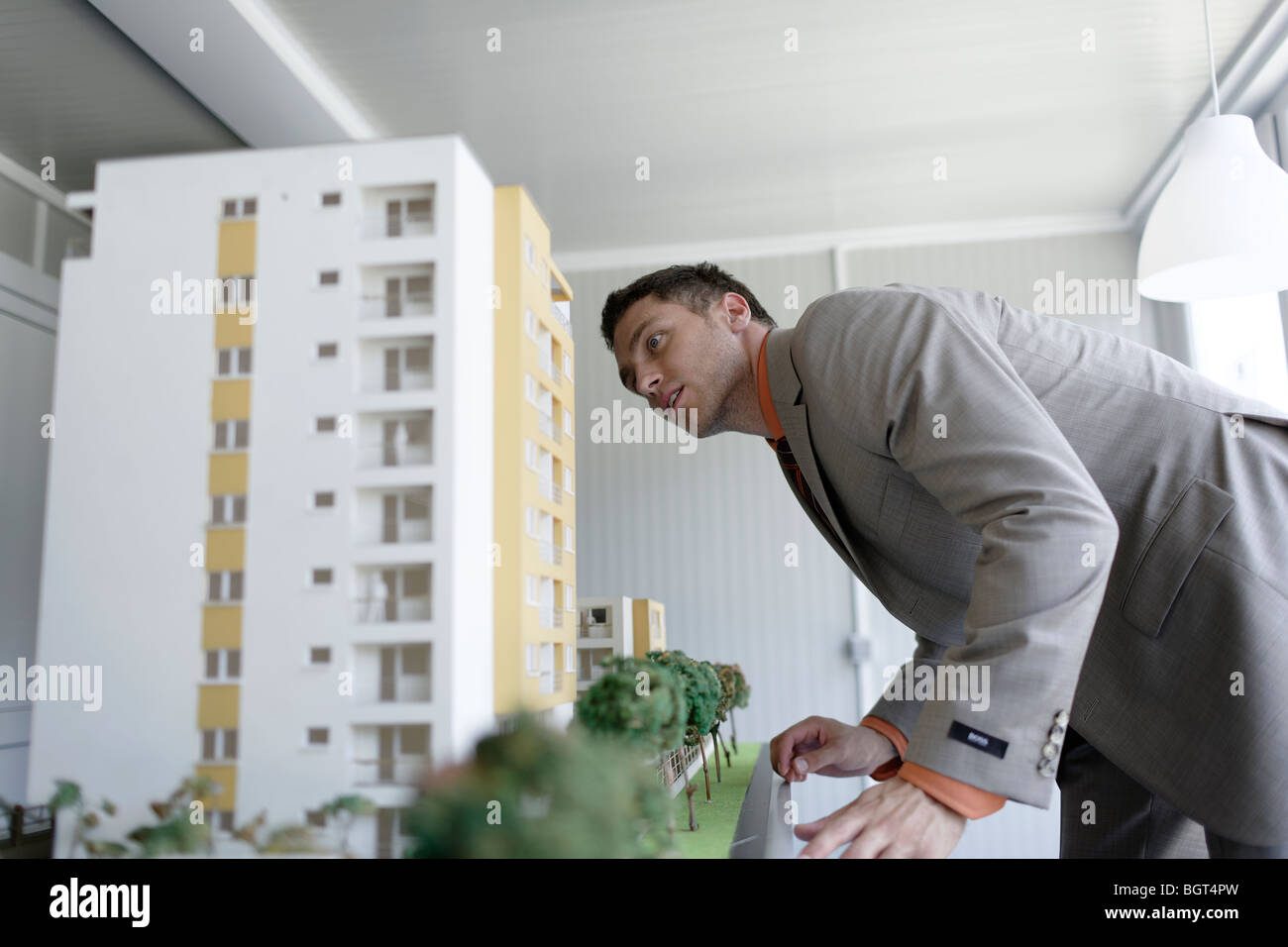 man looking at an architectural model building Stock Photo - Alamy