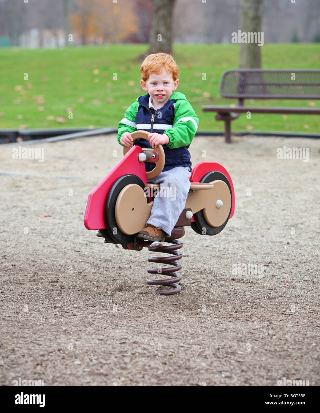 Boy on spring toy in kids playground Stock Photo - Alamy