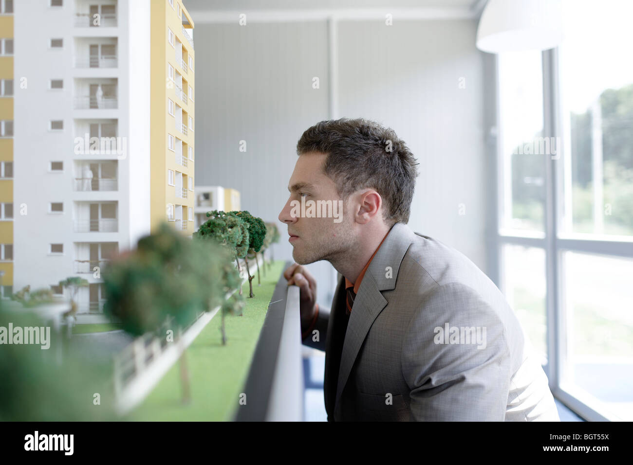 man looking at an architectural model building Stock Photo - Alamy