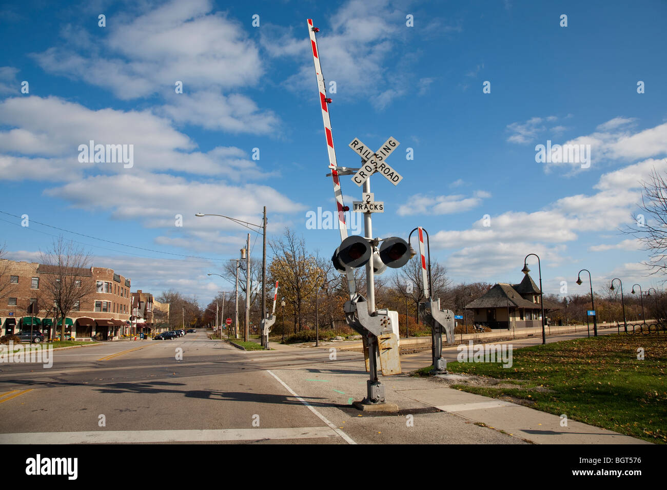 Railroad crossing with raised barrier in suburban america on a sunny ...