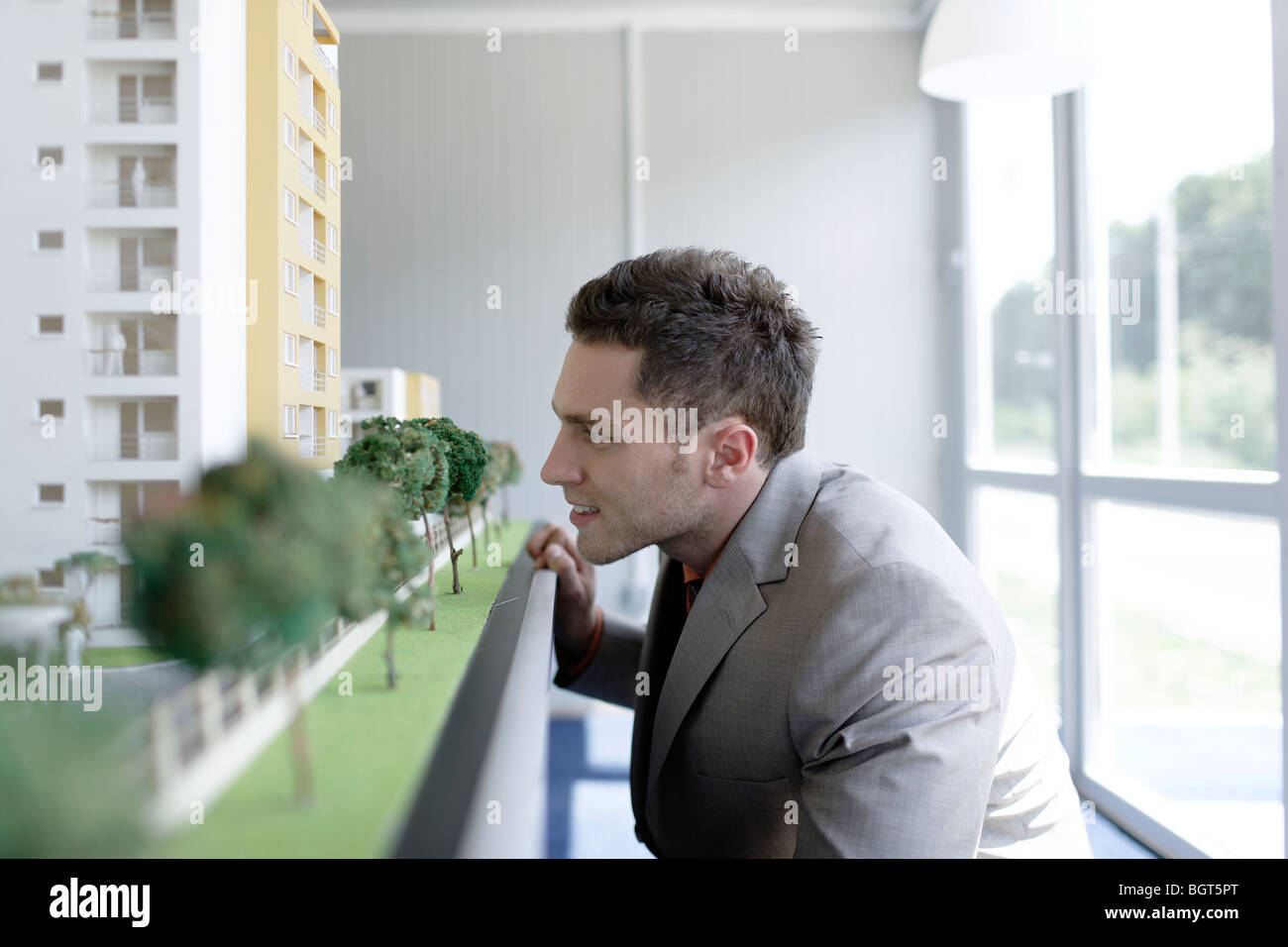 man looking at an architectural model building Stock Photo - Alamy