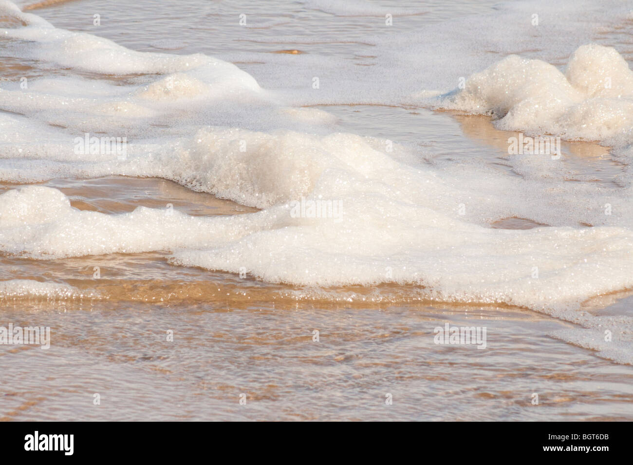 Foam Floating on the sea shore at Mundesley, Norfolk, England, UK Stock ...