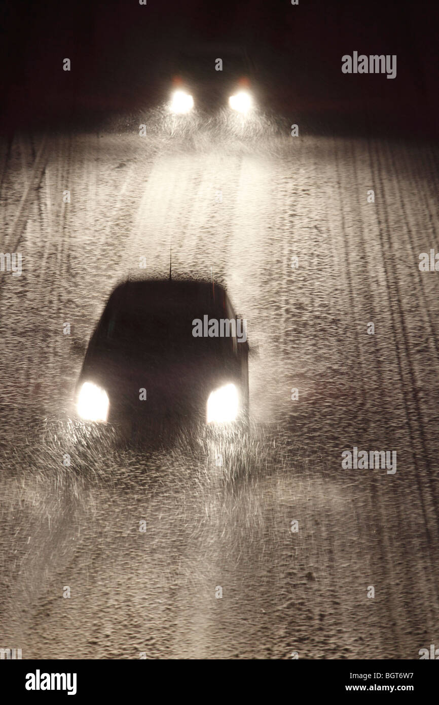 car driving in heavy snowfall on a snow covered road surface Stock ...