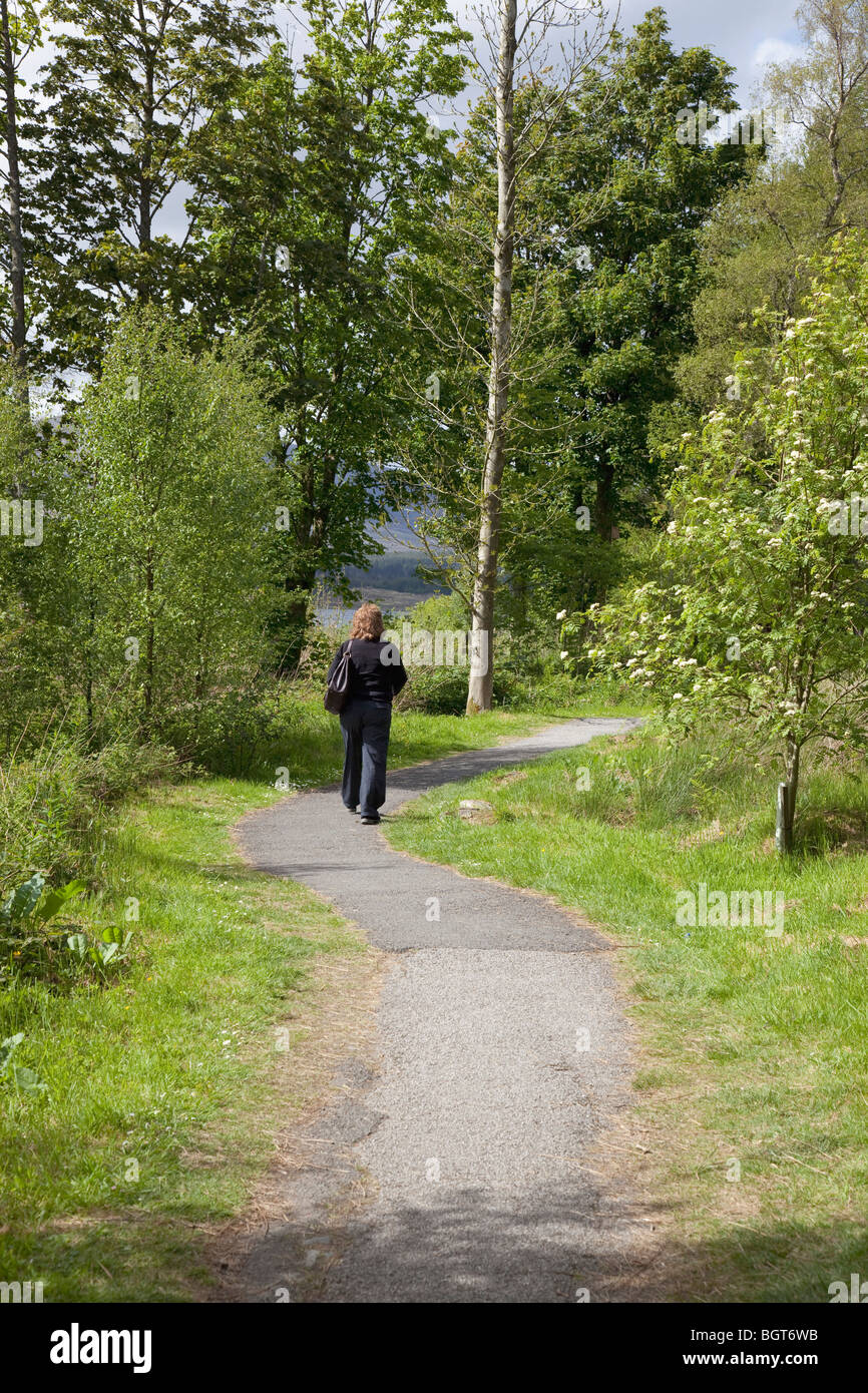 Woman walking on a path Stock Photo - Alamy