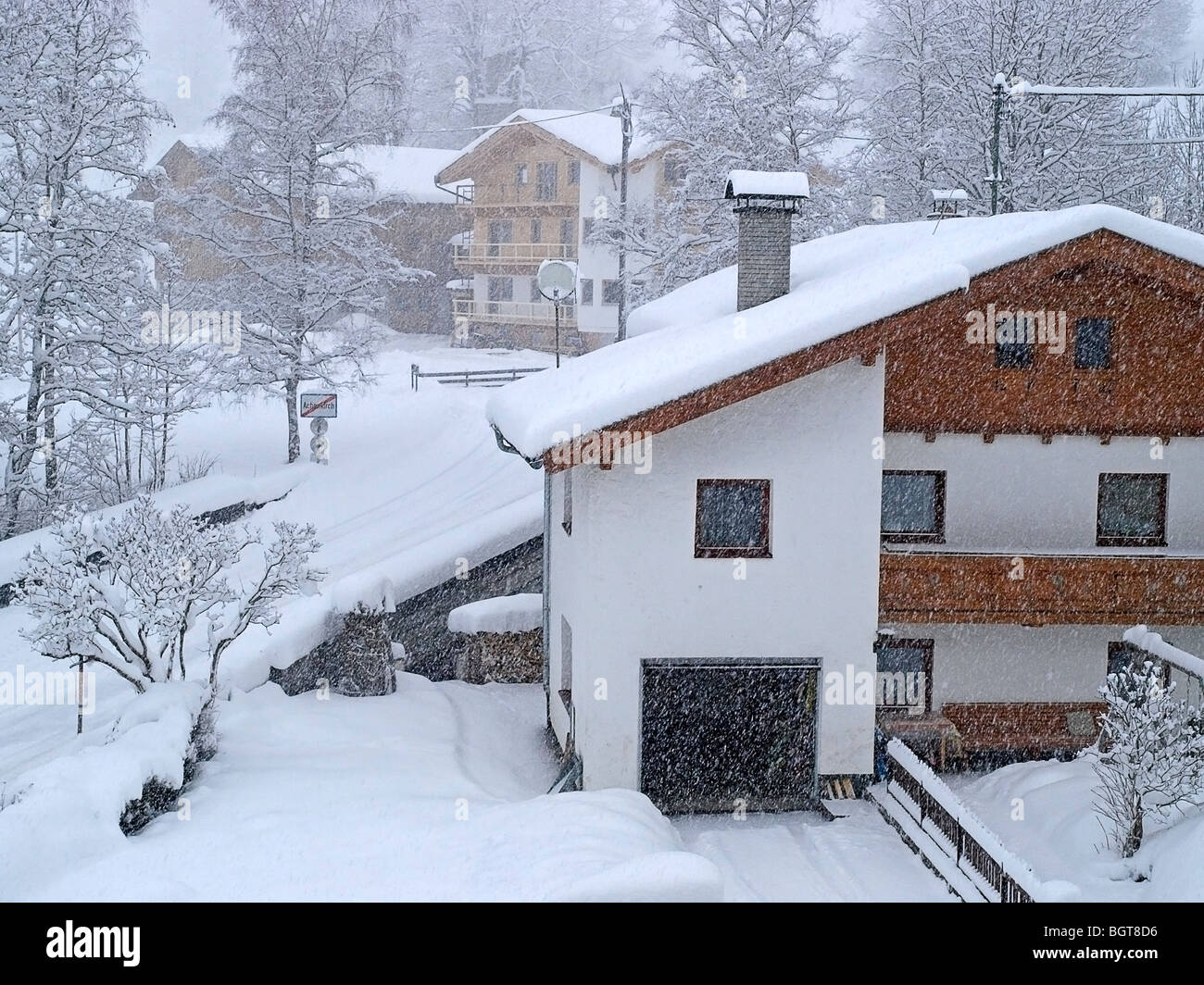 Snowfall in village wooden house hi-res stock photography and images ...