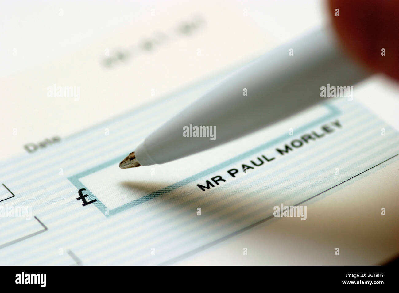 A close up of a cheque being signed Stock Photo - Alamy