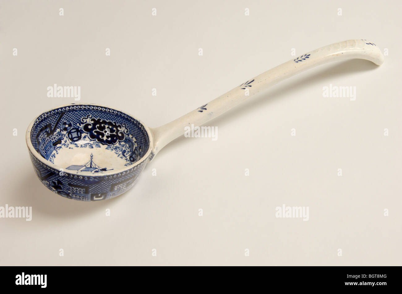 A blue and white pottery ladle decorated with transfer prints, probably ...