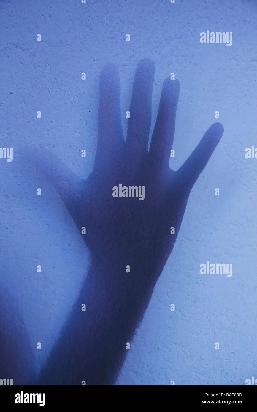 Silhouette of open hand against wall Stock Photo - Alamy