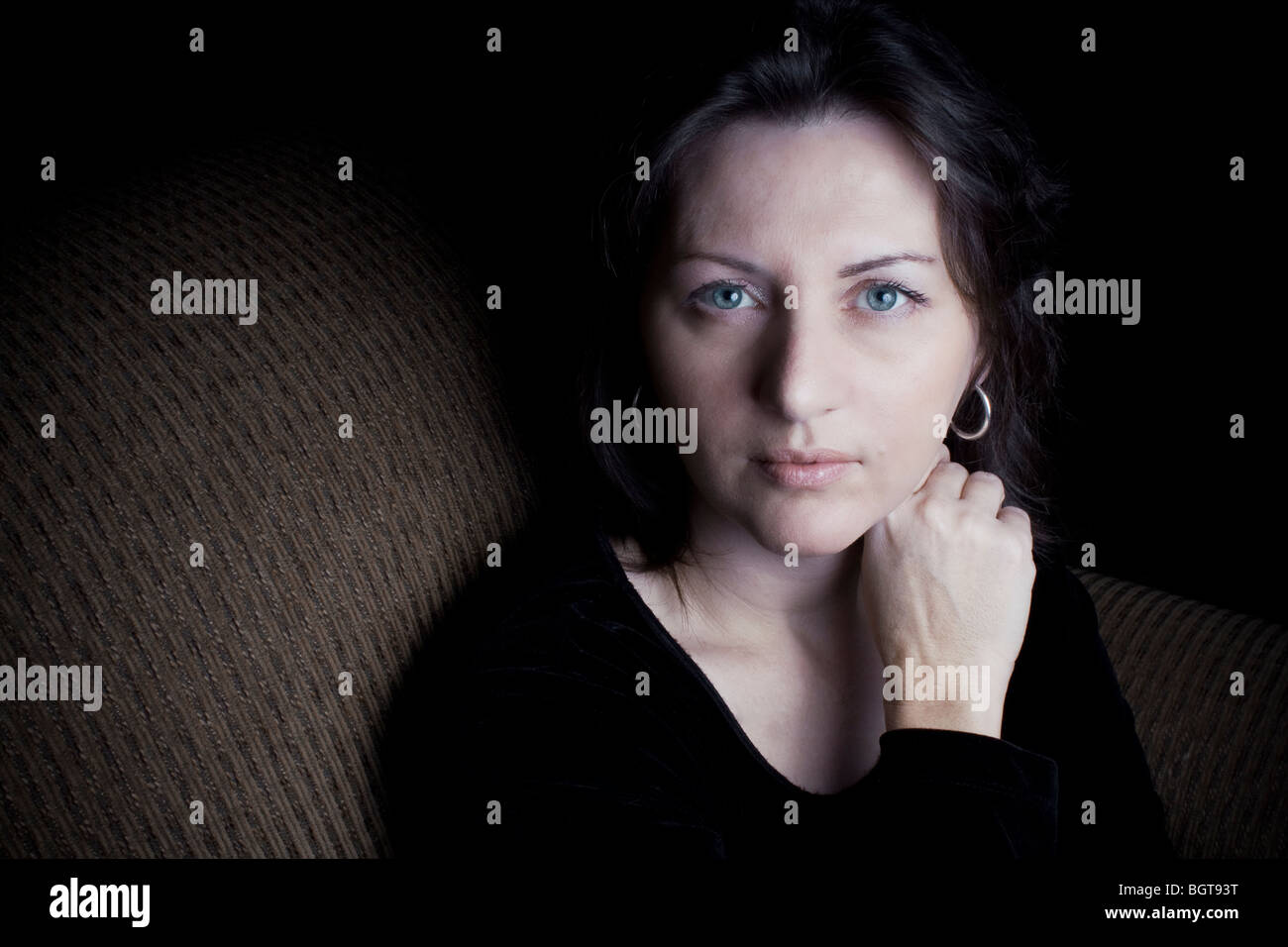 Beautiful Adult Woman Sitting in Arm Chair Stock Photo - Alamy