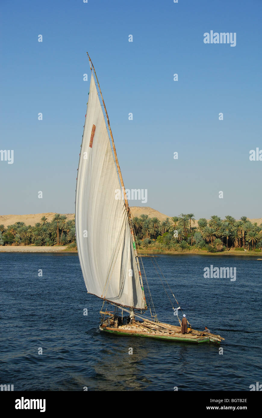 RIVER NILE, UPPER EGYPT. A working felucca, carrying rocks and stones ...