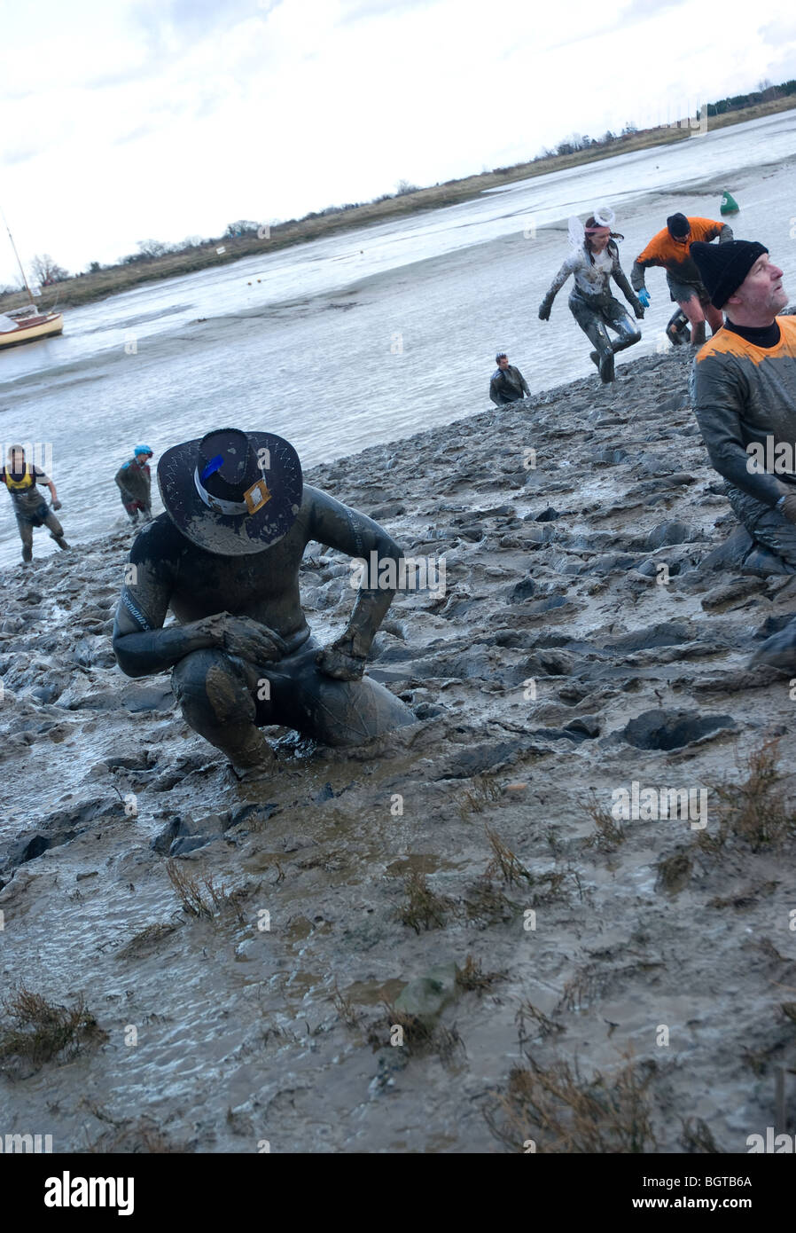 a cowboy knees in the mud at the maldon mud race Stock Photo - Alamy