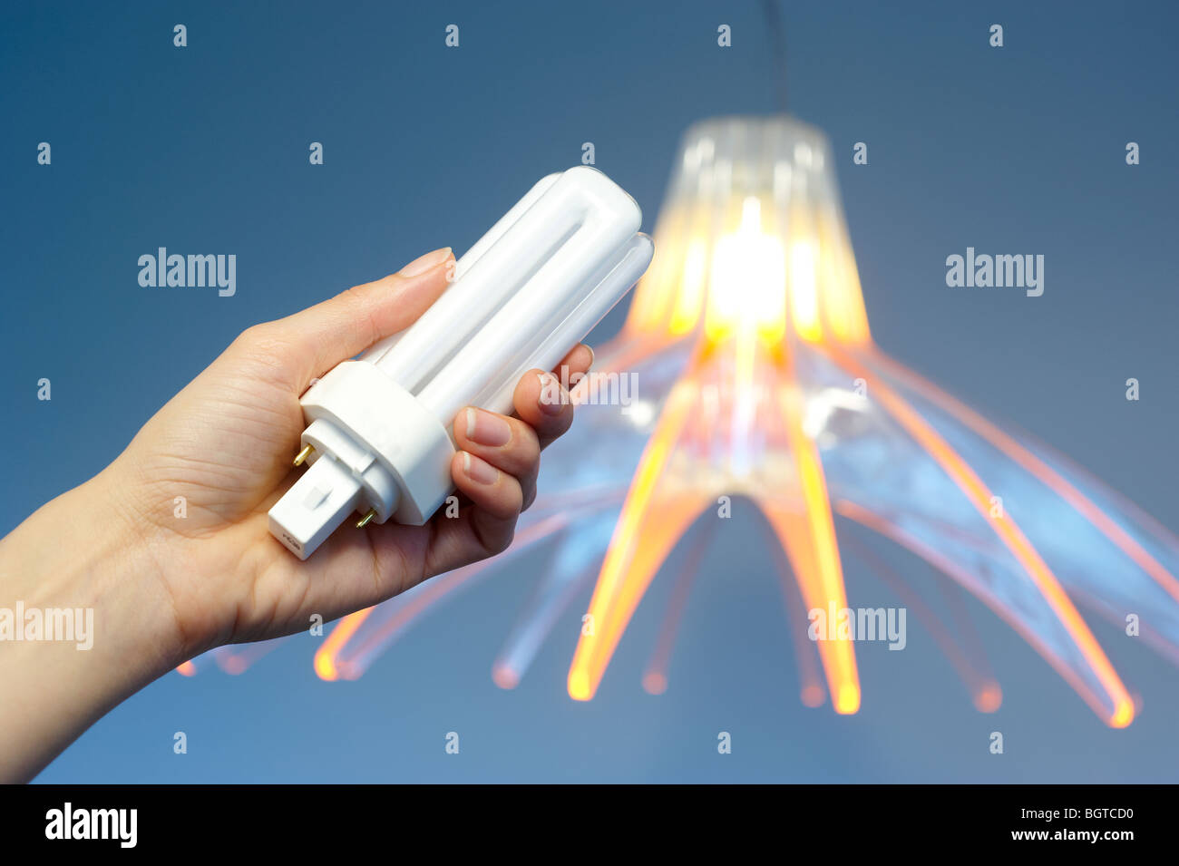 Hand holding energy saving bulb Stock Photo - Alamy