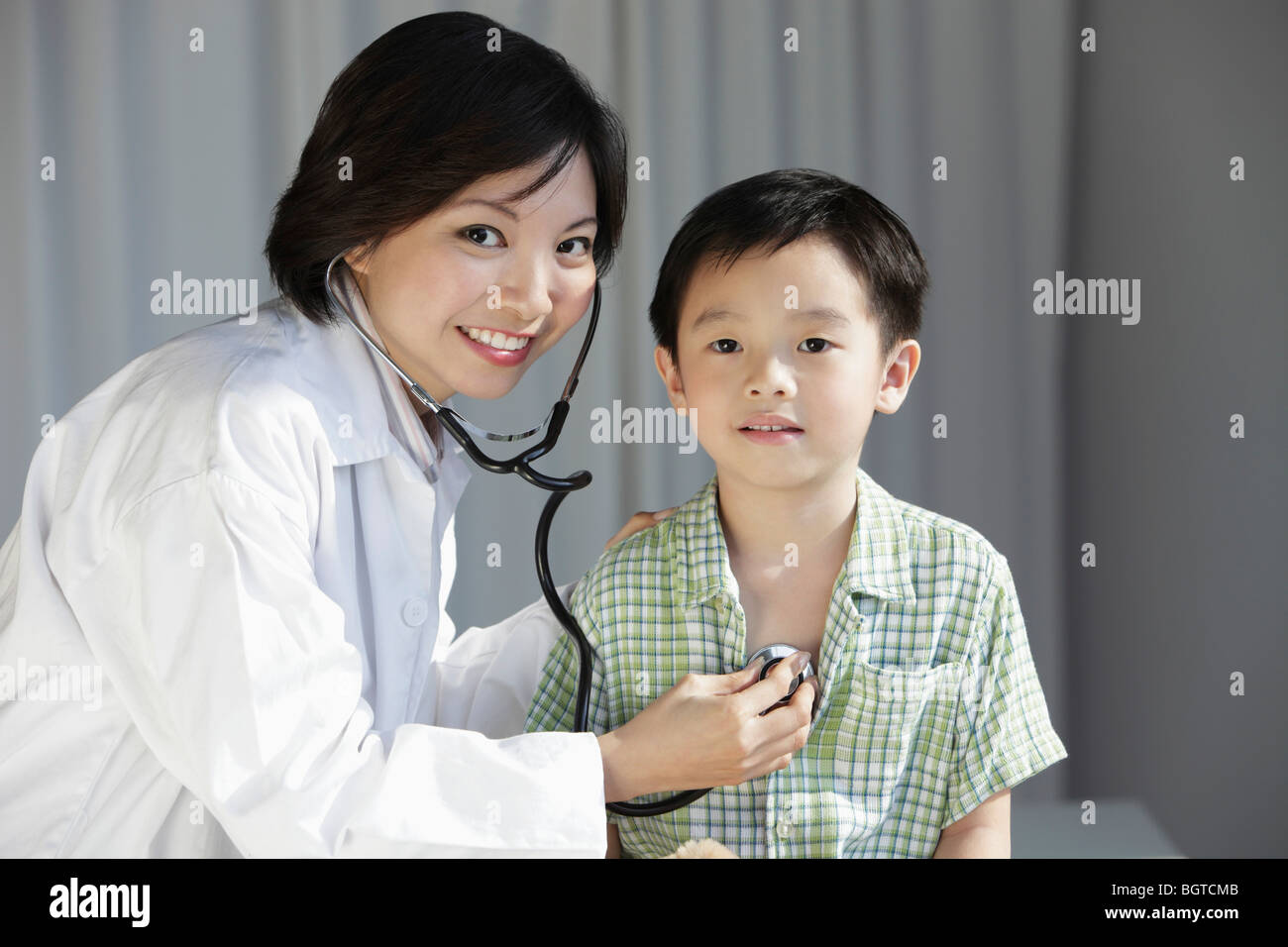Doctor giving a young boy a check up Stock Photo - Alamy