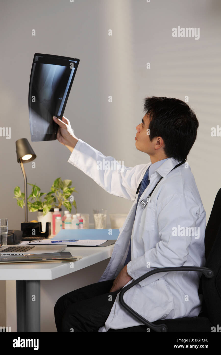 Doctor looking at X ray Stock Photo - Alamy