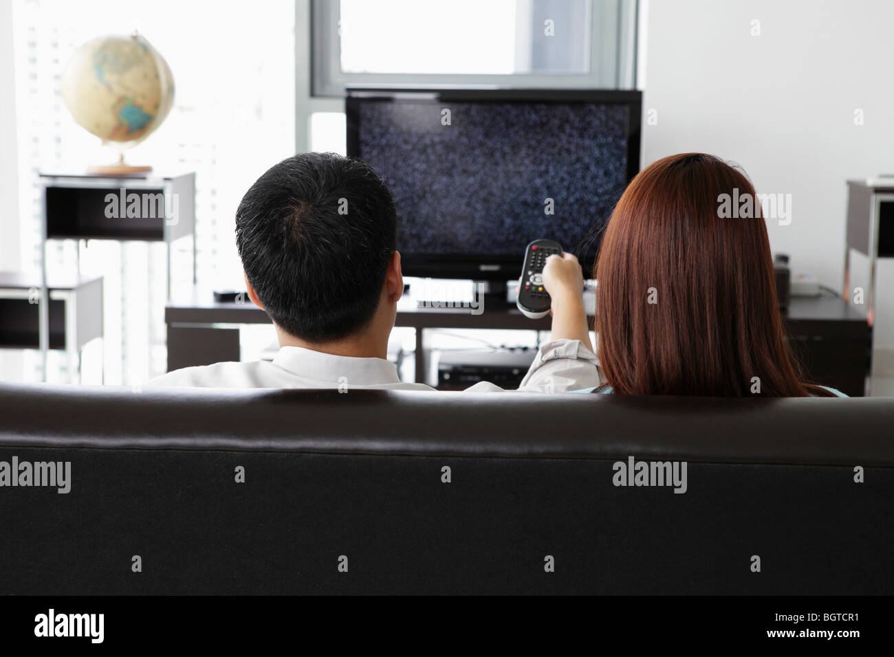 Rear view young woman watching hi-res stock photography and images - Alamy