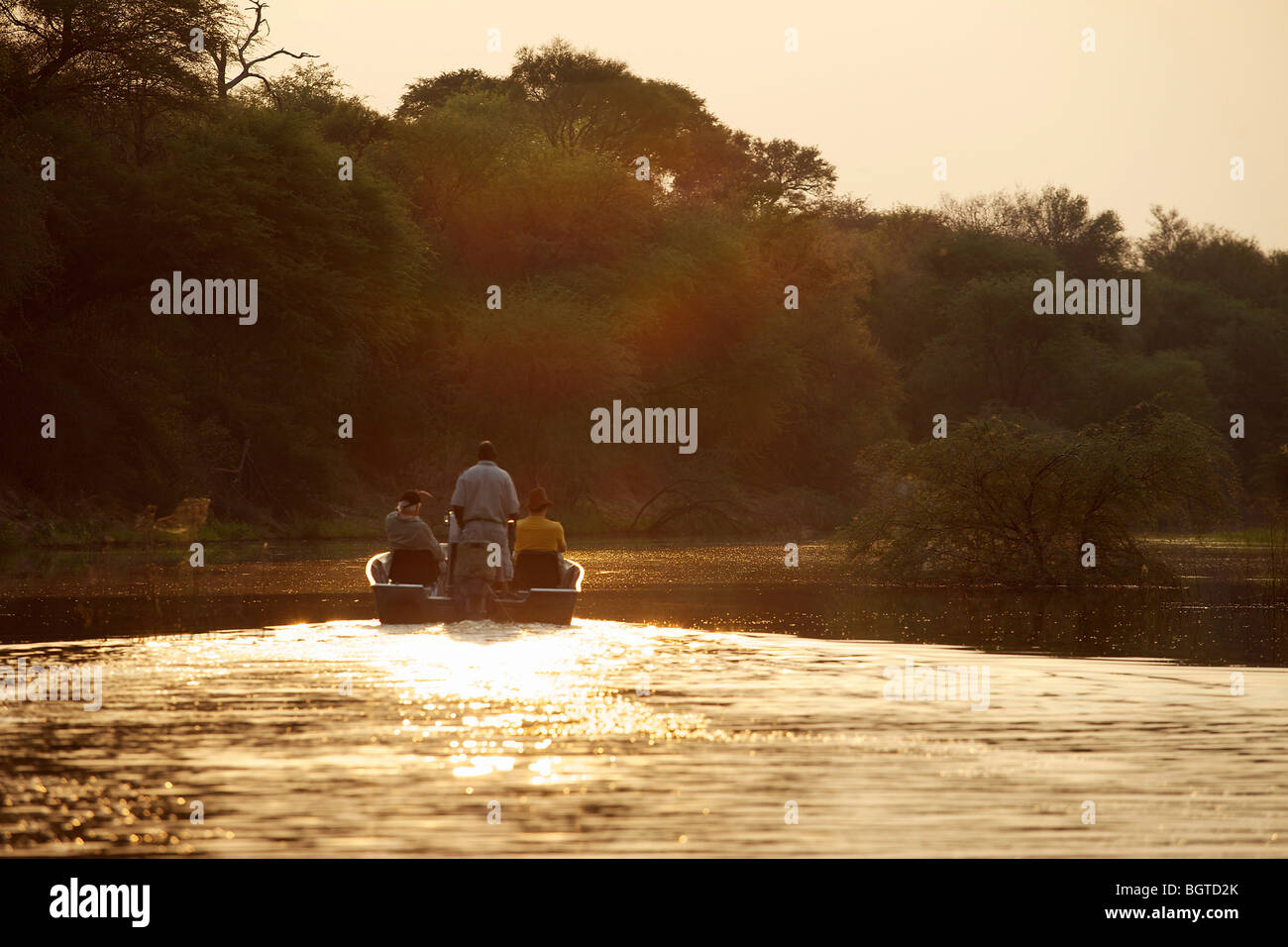 Boat on Boteti River at sunset, Botswana Stock Photo - Alamy