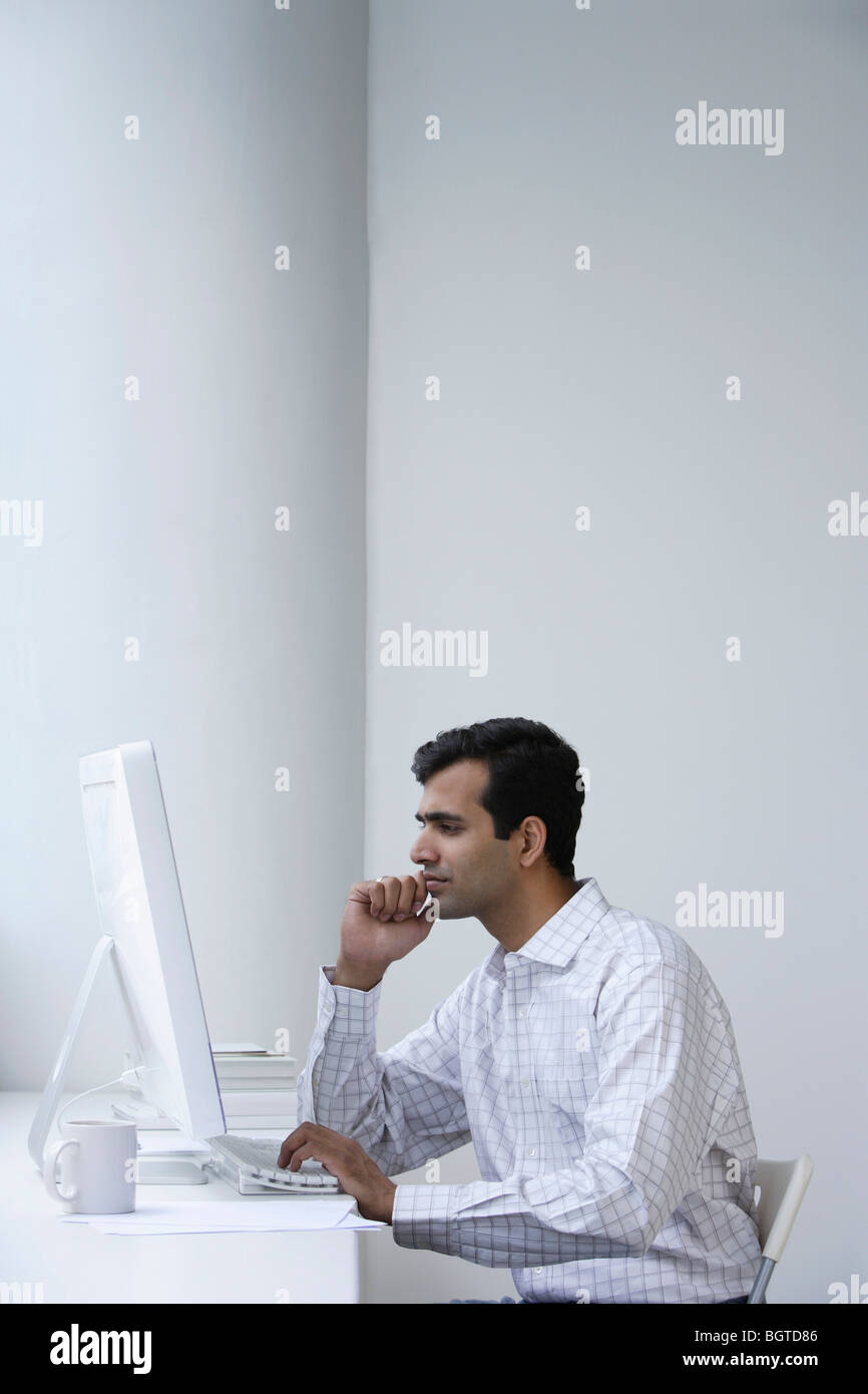Indian man working on computer Stock Photo - Alamy