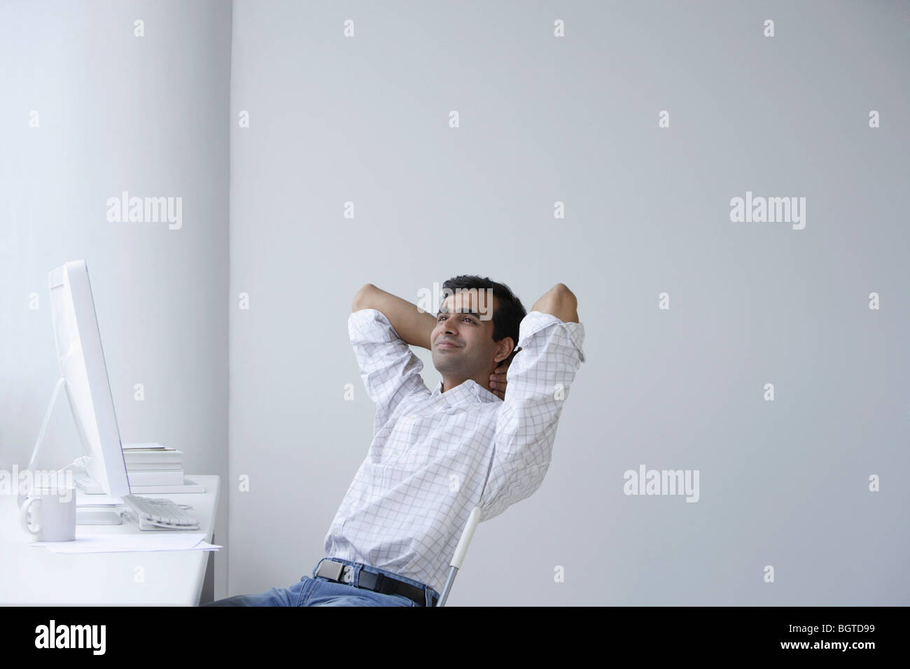 Indian man relaxing in front of the computer Stock Photo - Alamy