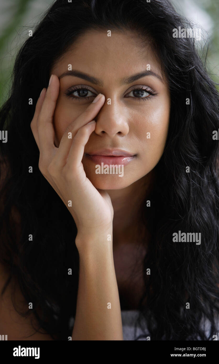 Head shot of Indian woman with hand on her face Stock Photo - Alamy