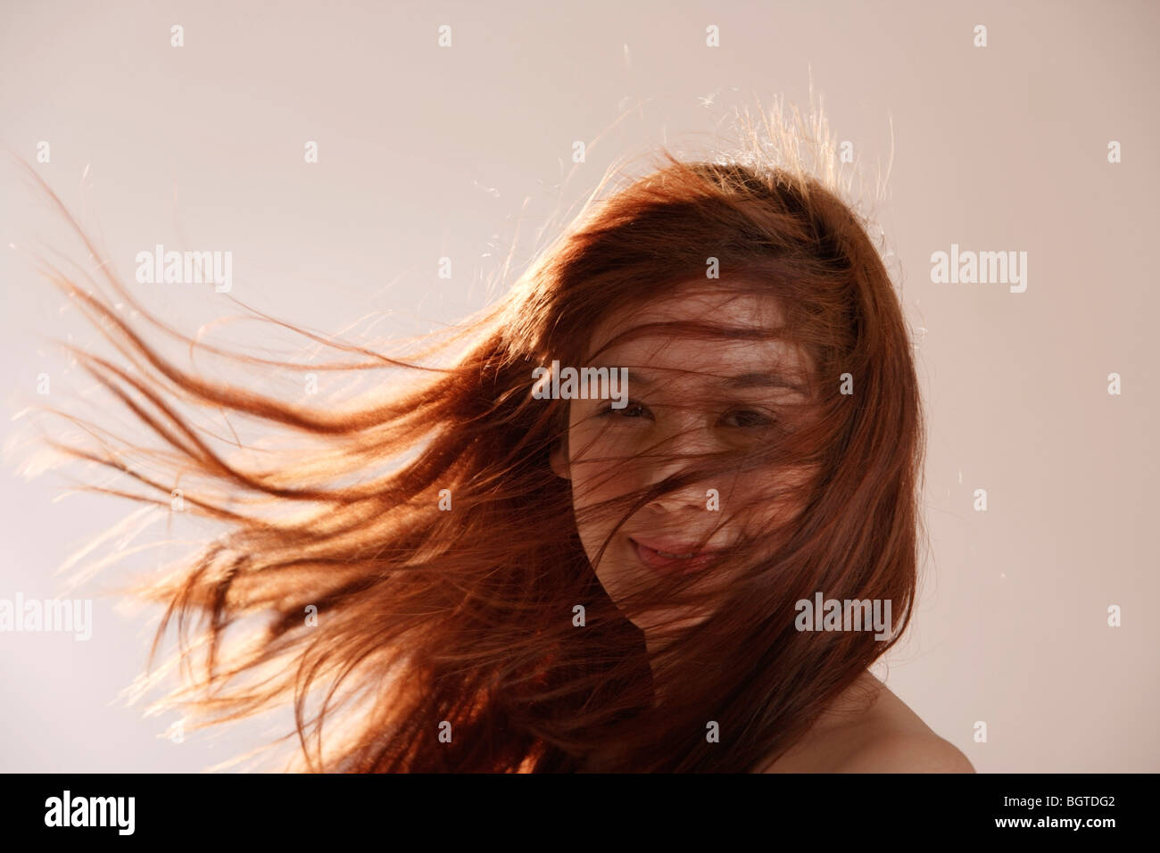 Young Asian girl with hair blowing in the wind Stock Photo - Alamy