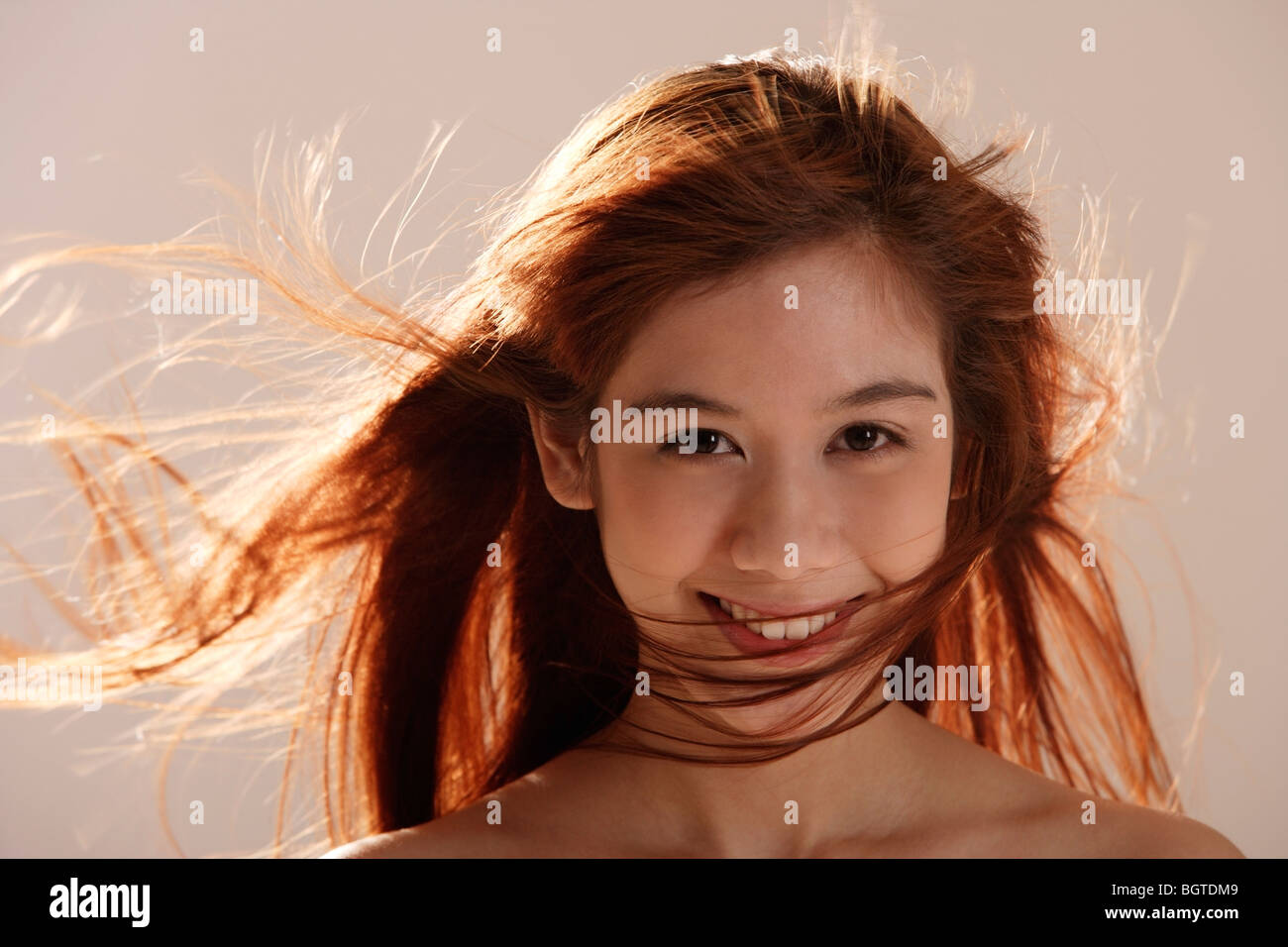 Asian girl with wind blown hair Stock Photo - Alamy