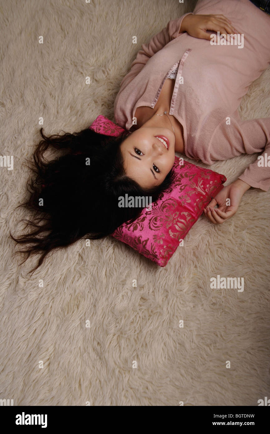 Woman home laying on rug hi-res stock photography and images - Alamy