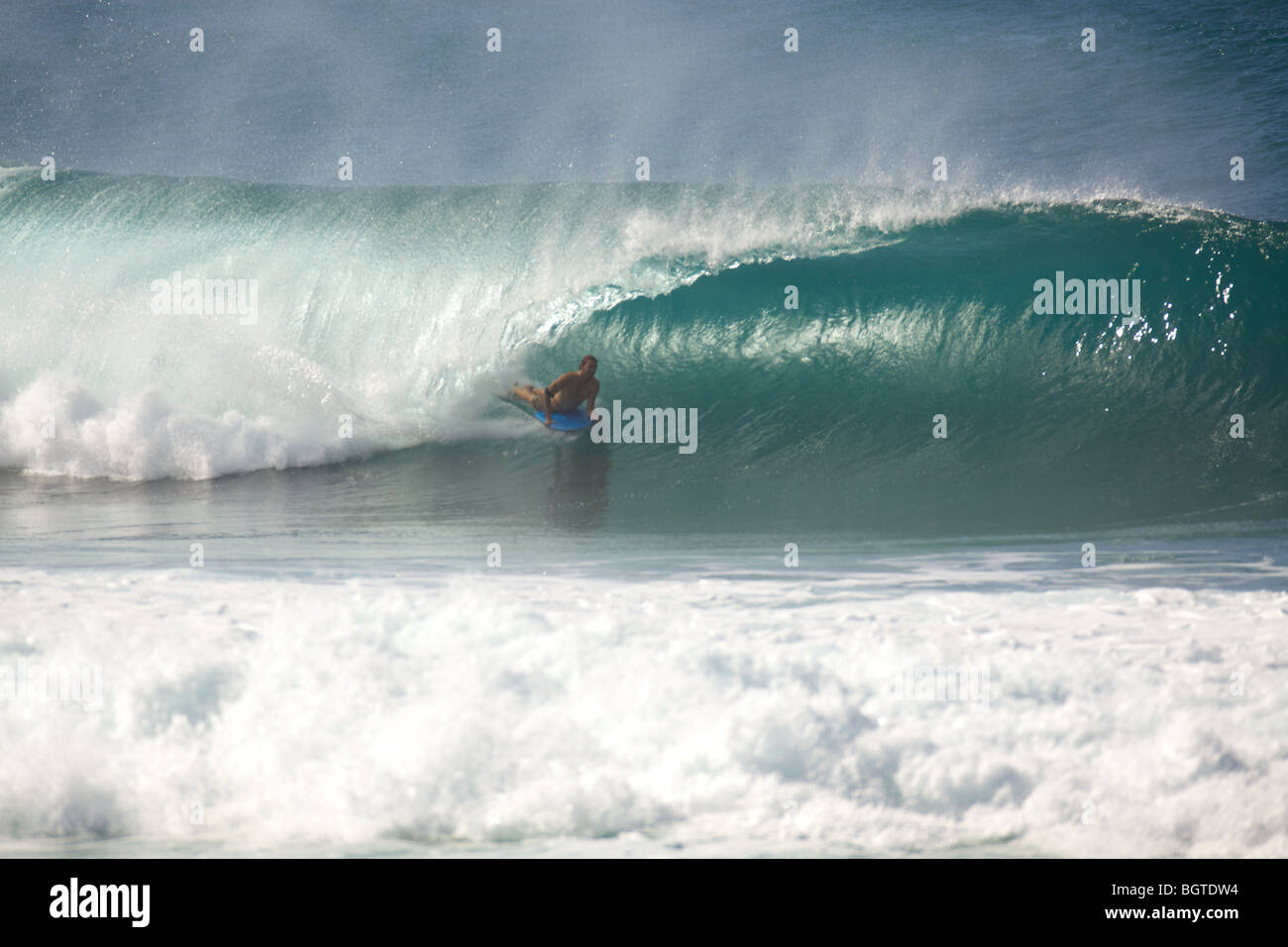A body boarder rides a large wave, inside the barrel, at Pipeline ...