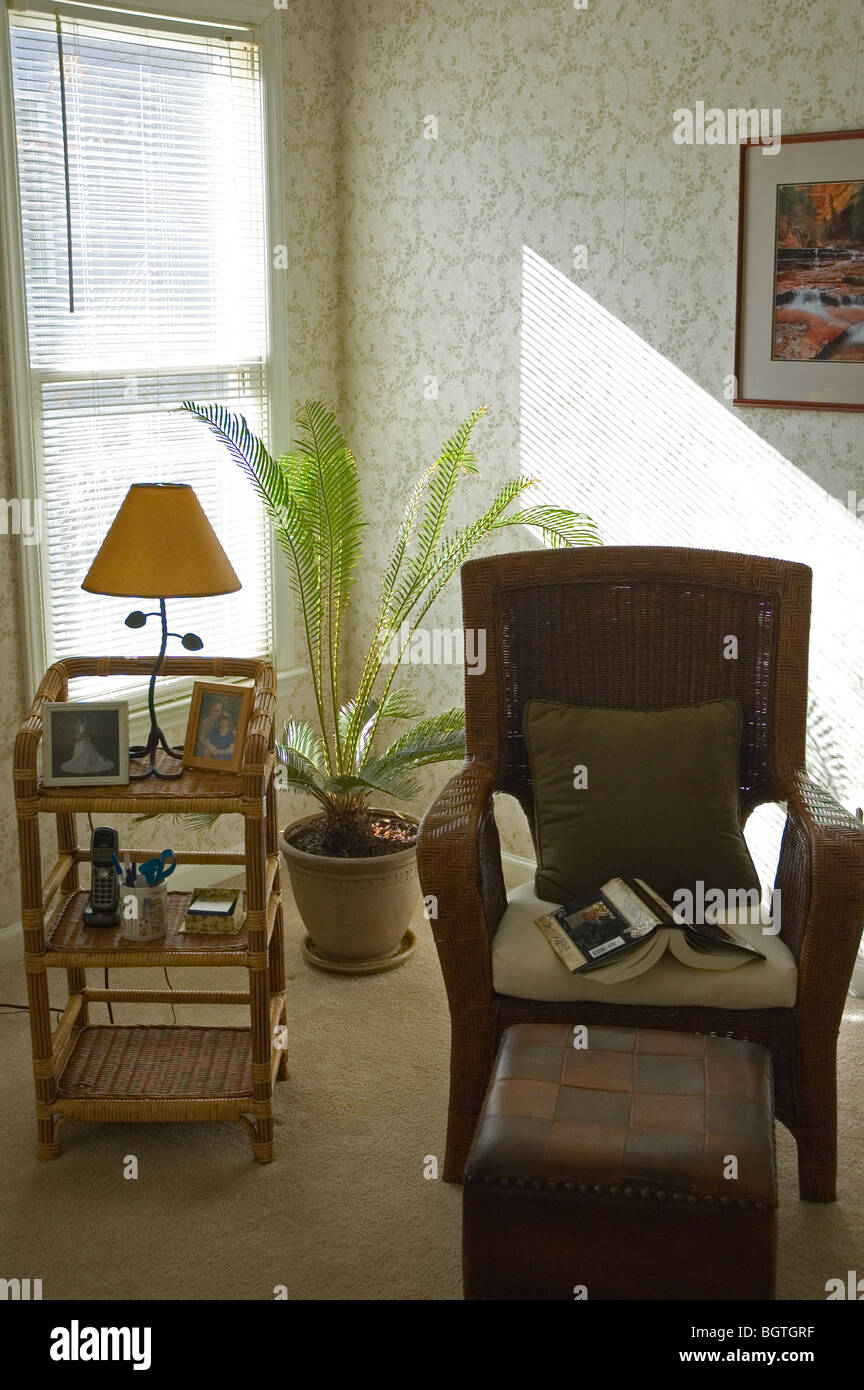 A comfortable chair with sun streaming through window Stock Photo - Alamy