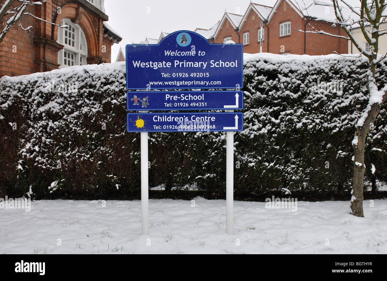 Primary school sign in winter with snow, UK Stock Photo - Alamy