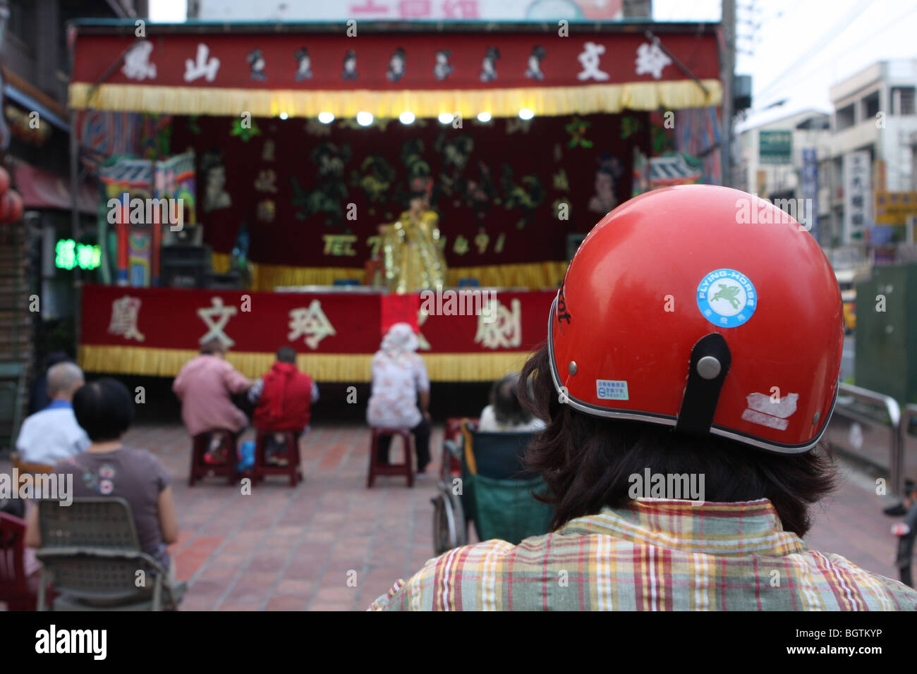 man wearing an helmet for watch a temple show Stock Photo - Alamy
