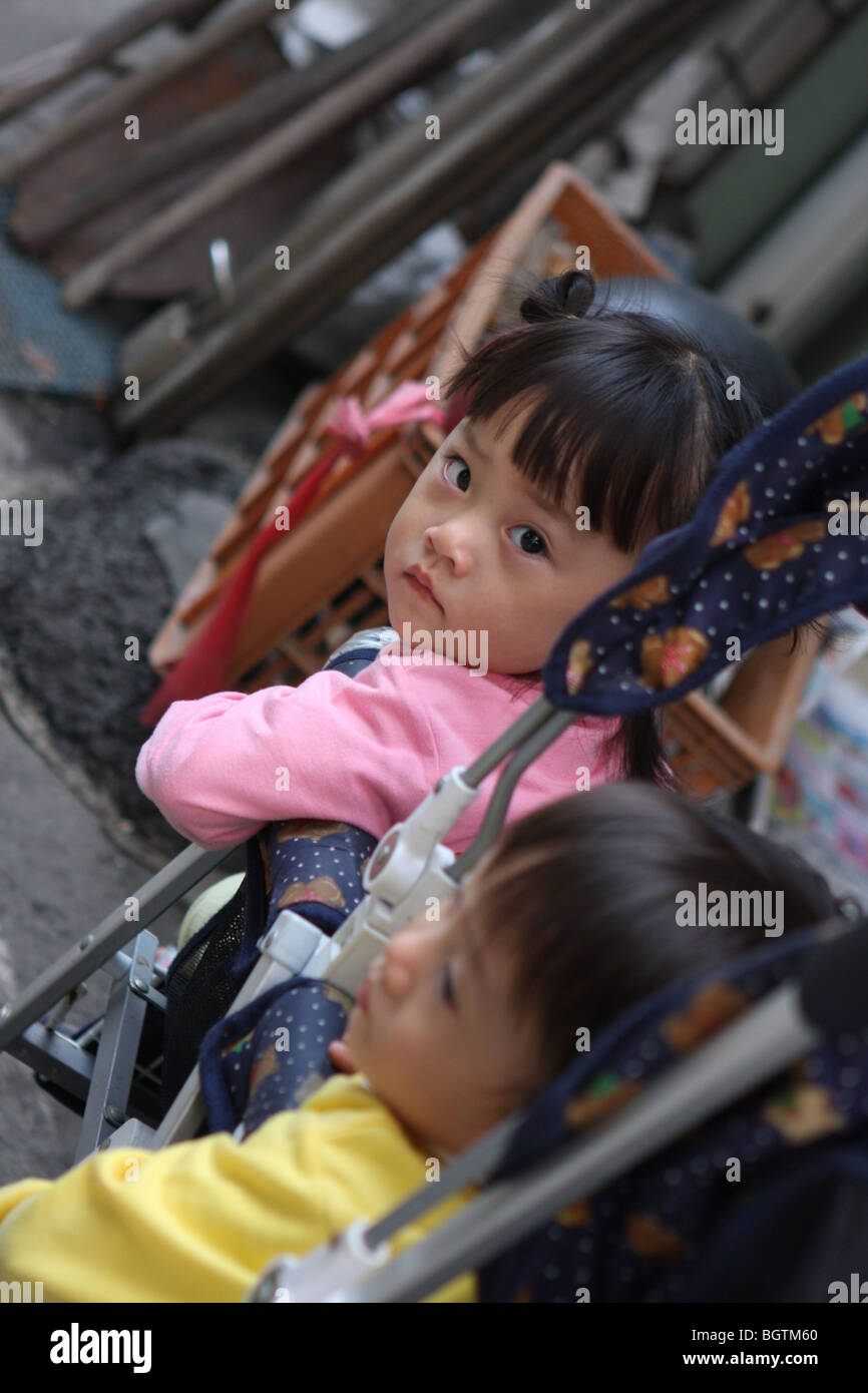 children in a double baby-buggy Stock Photo - Alamy