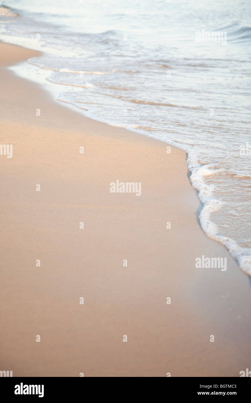Gentle surf lapping against a golden shore Stock Photo - Alamy