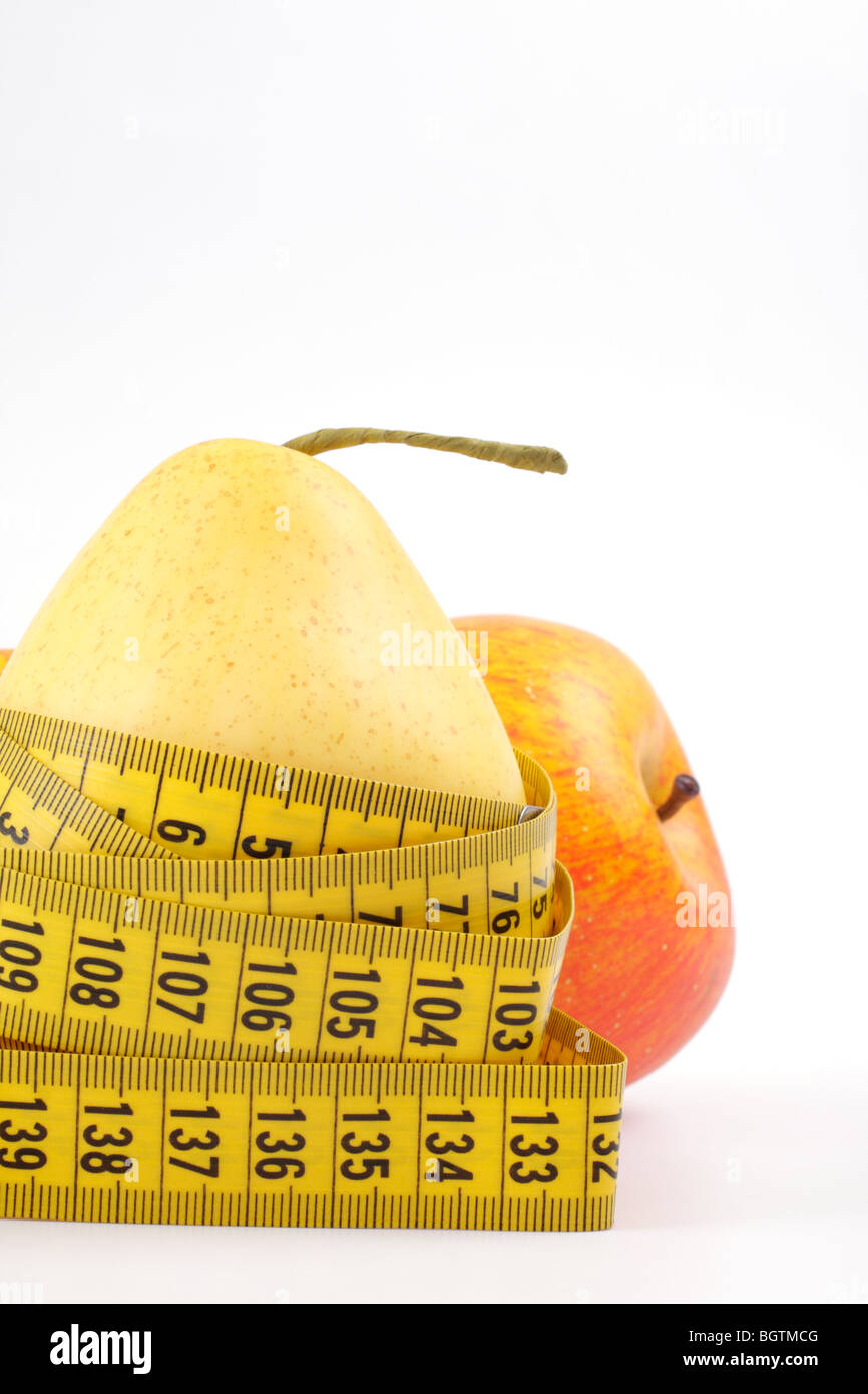 Pear and apple with a measuring tape, studio isolated. Fruit artificial ...