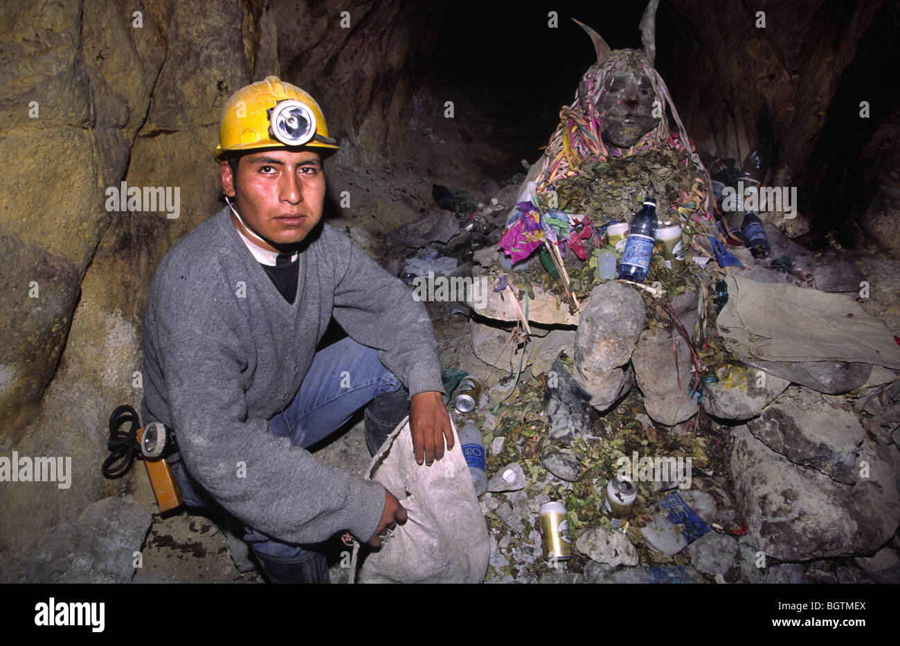 Miner sacrificing coca leaves to "El Tio", the lord of the underworld ...