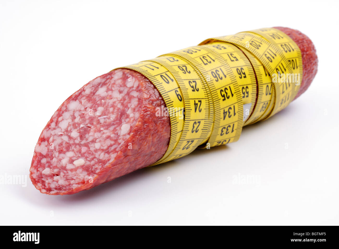Sausage with a measuring tape, studio isolated Stock Photo - Alamy
