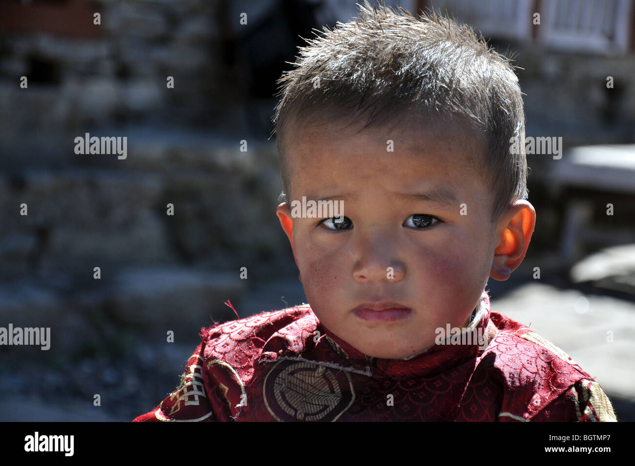 Nepalese boy in traditional costume looking soulfully into camera Stock ...