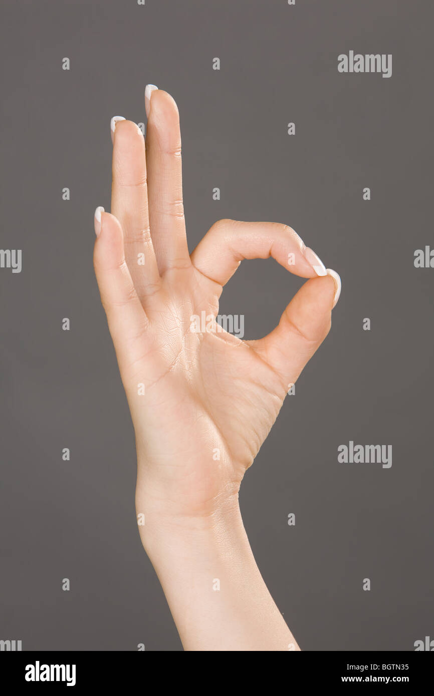 Caucasian female using hand gestures to say ok Stock Photo - Alamy
