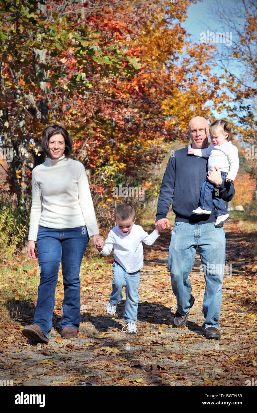 Happy family walking on path in fall Stock Photo - Alamy