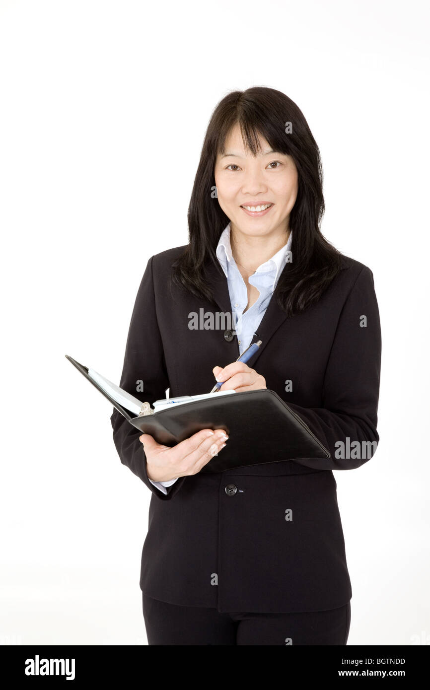 Beautiful Asian Businesswoman working with a day planner on a white ...