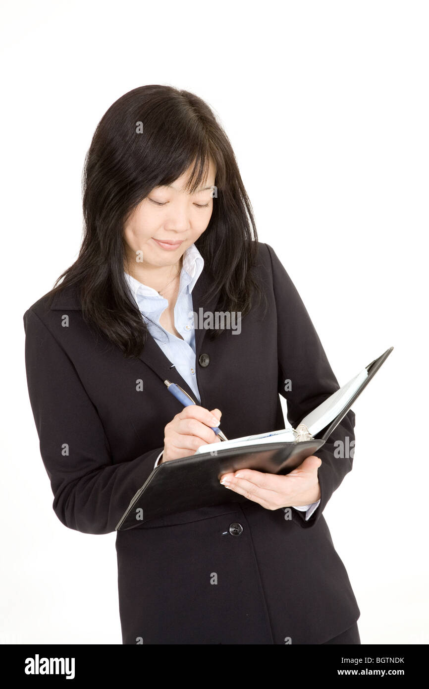 Beautiful Asian Businesswoman working with a day planner on a white ...